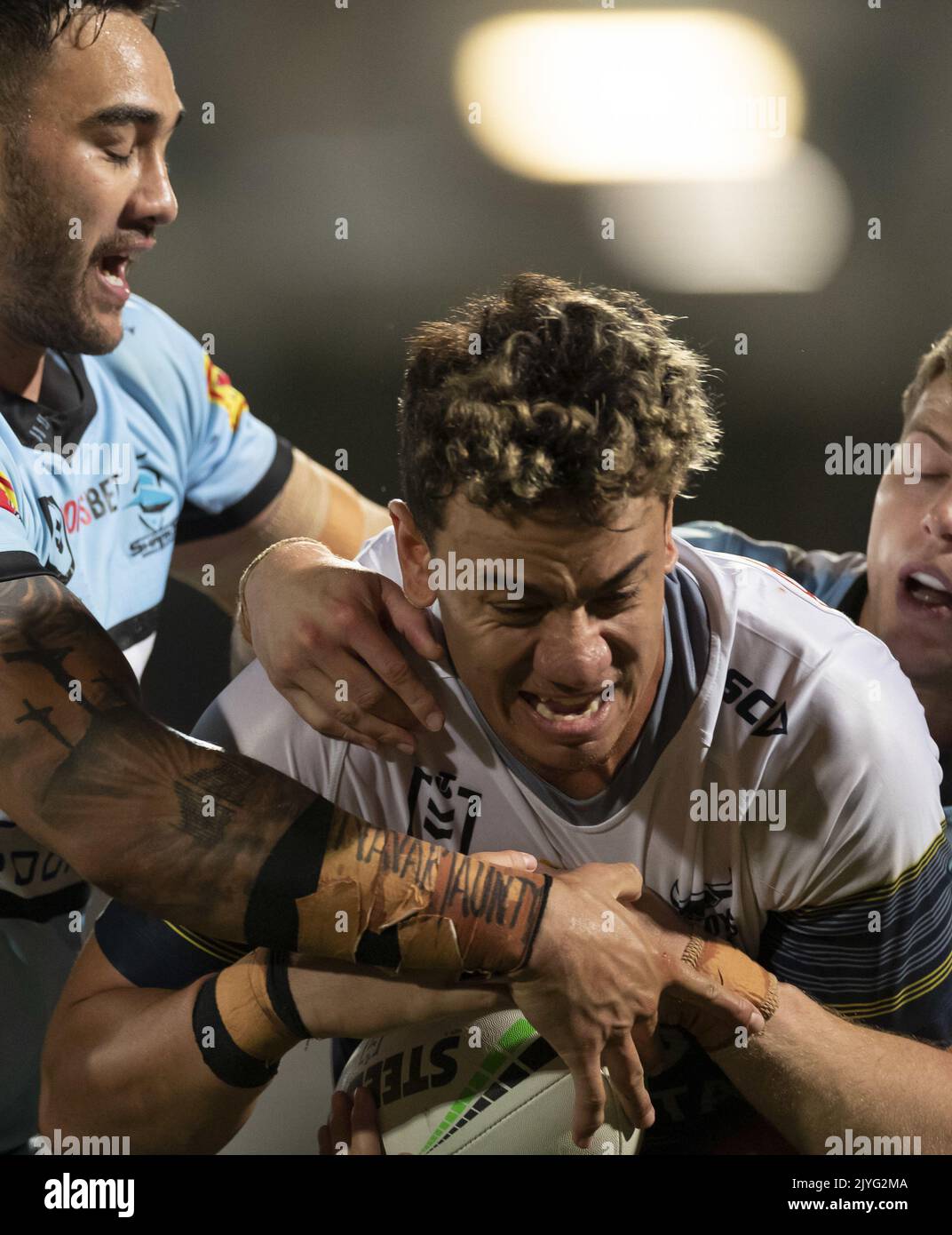 Daejarn Asi of the Cowboys is tackled during the Round 16 NRL match ...