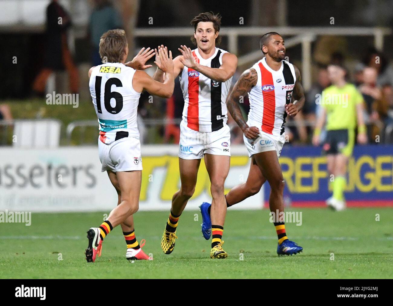 Jack Steele (centre) of the Saints celebrates kicking a goal with Dan ...