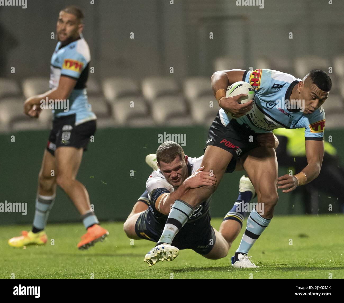 Tom Gilbert of the Cowboys tackles Sione Katoa of the Sharks during the ...