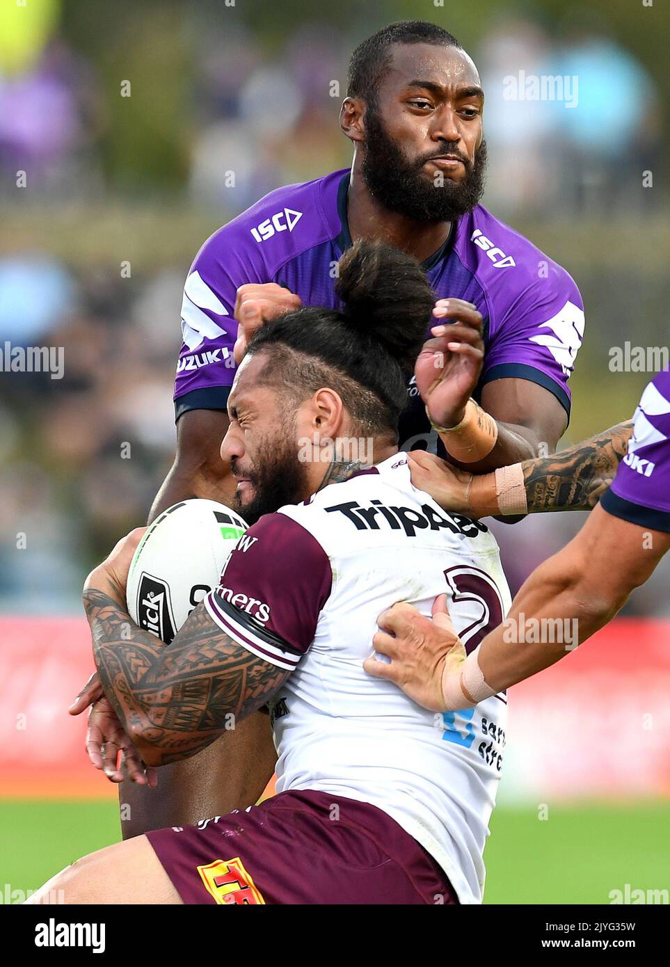 Jorge Taufua of the Sea Eagles (bottom) is stopped by Isaac Lumelume of ...