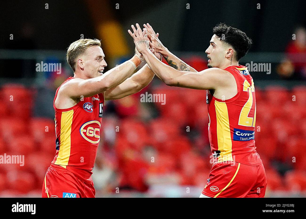 Izak Rankine of the Suns (right) reacts with Darcy MacPherson after ...