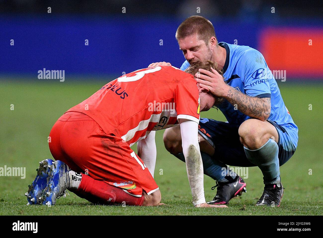 Luke Brattan of Sydney consoles Nathaniel Atkinson of City following ...