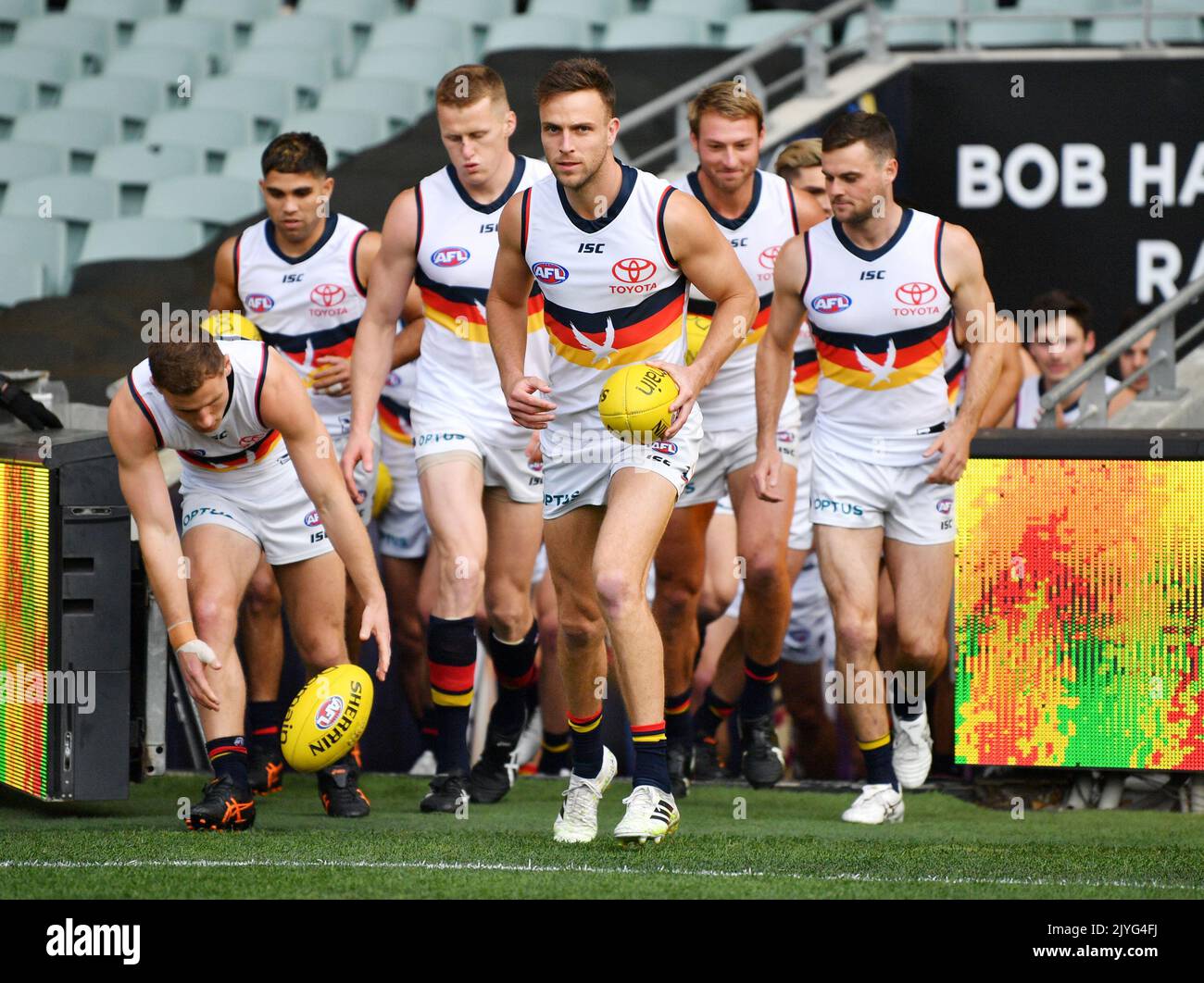 Crows players run onto the field during the Round 15 AFL match between ...