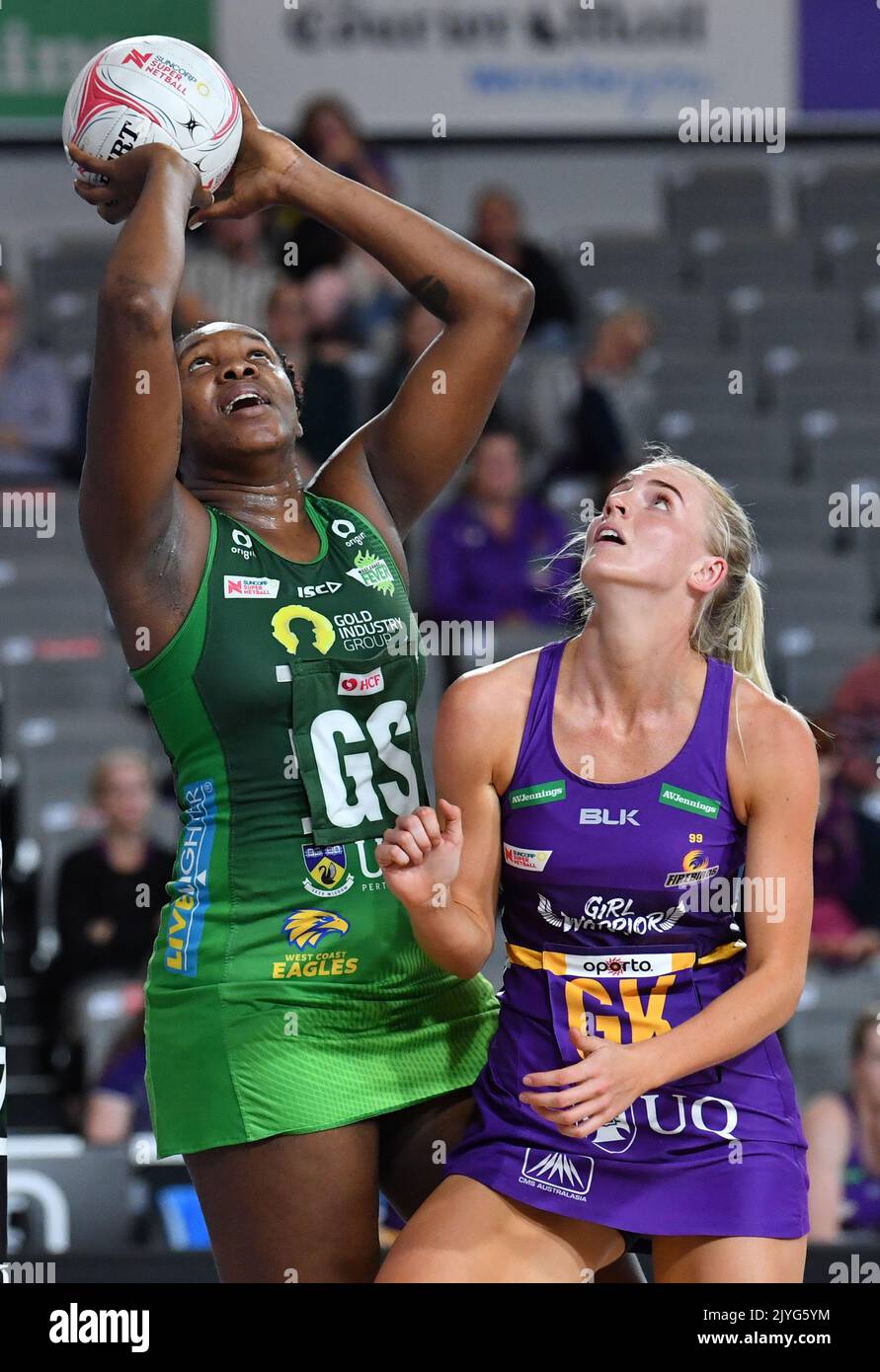 Jhaniele Fowler (left) of the Fever shoots for goal over Rudi Ellis ...