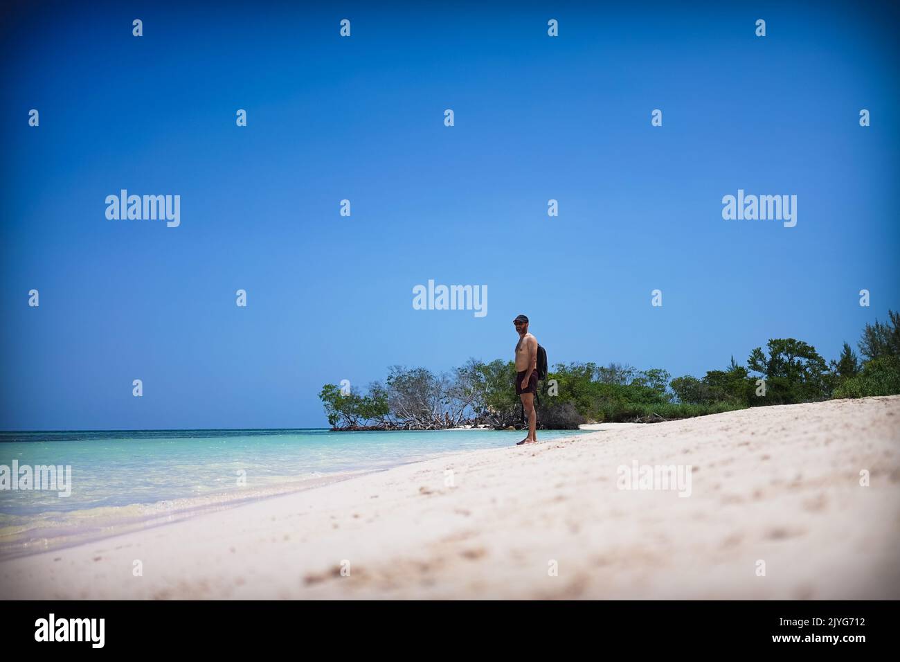 a single person standing on a dreamy beach Stock Photo - Alamy