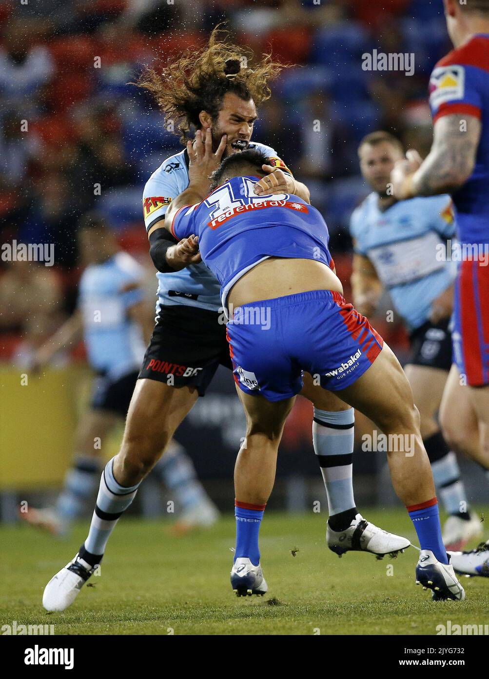 Toby Rudolf of the Sharks is tackled during the Round 17 NRL match ...