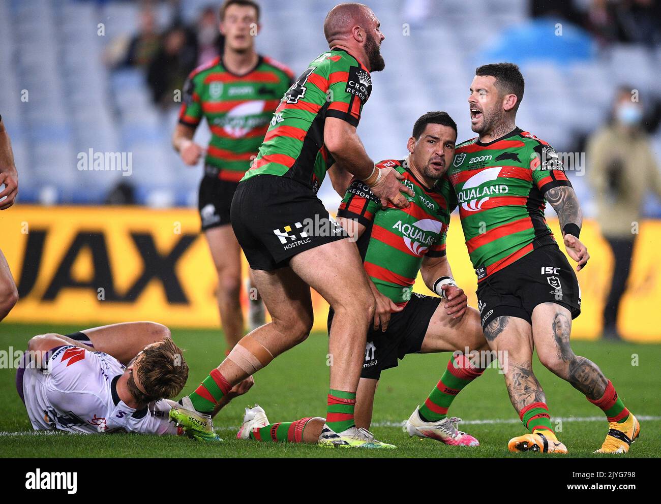 Cody Walker of the Rabbitohs celebrates with Mark Nicholls (left) and ...