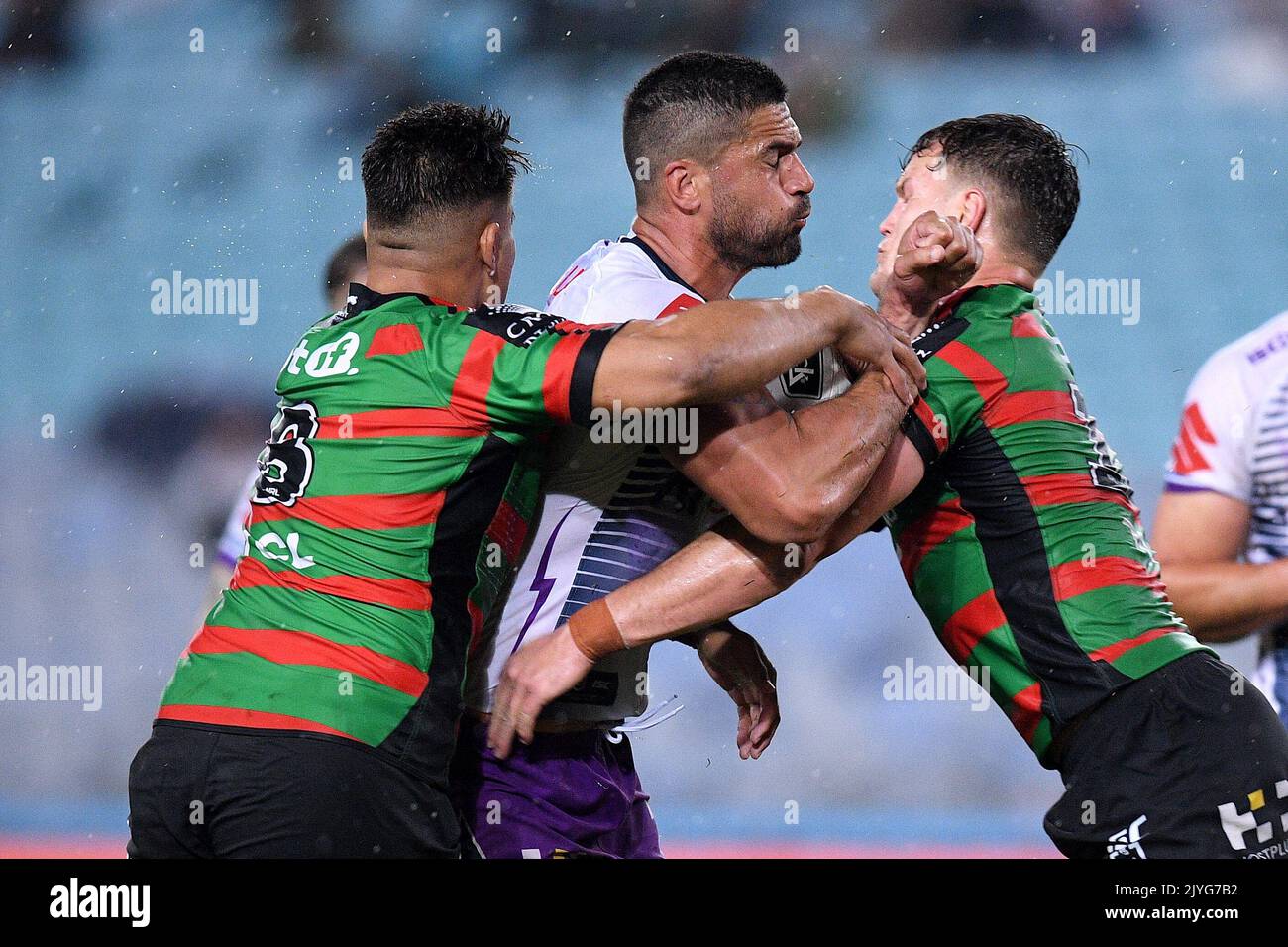 Jesse Bromwich of the Storm is tackled by Tevita Tatola (left) and Liam ...