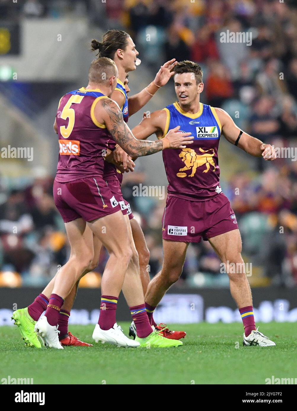 Jarryd Lyons (right) of the Lions celebrates kicking a goal with team ...
