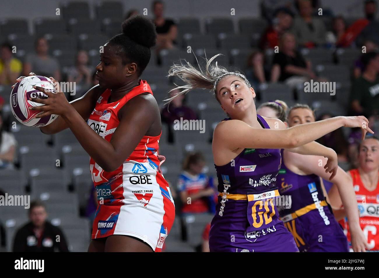 Sam Wallace of the Swifts and Kim Jenner of the Firebirds compete for ...