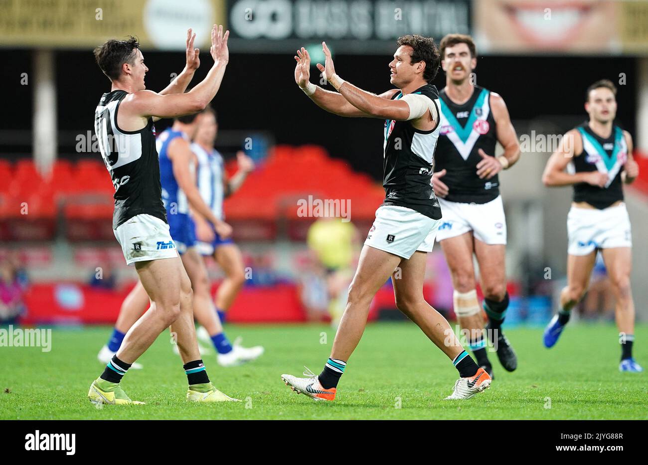 Steven Motlop of the Power (right) reacts after kicking a goal during ...