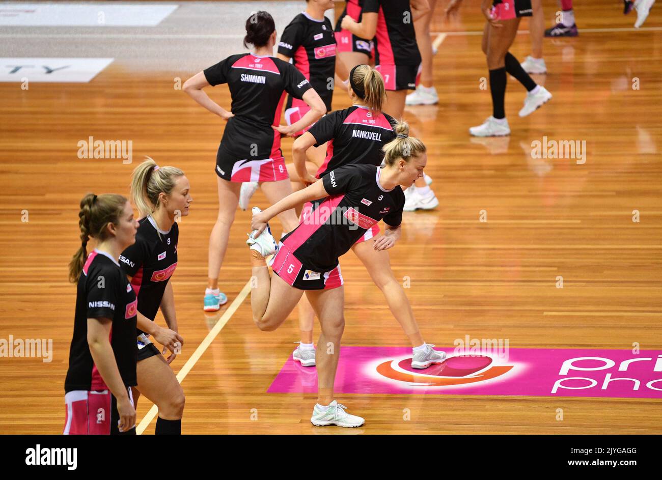 Thunderbird players warm up before the Round 11 Super Netball match ...