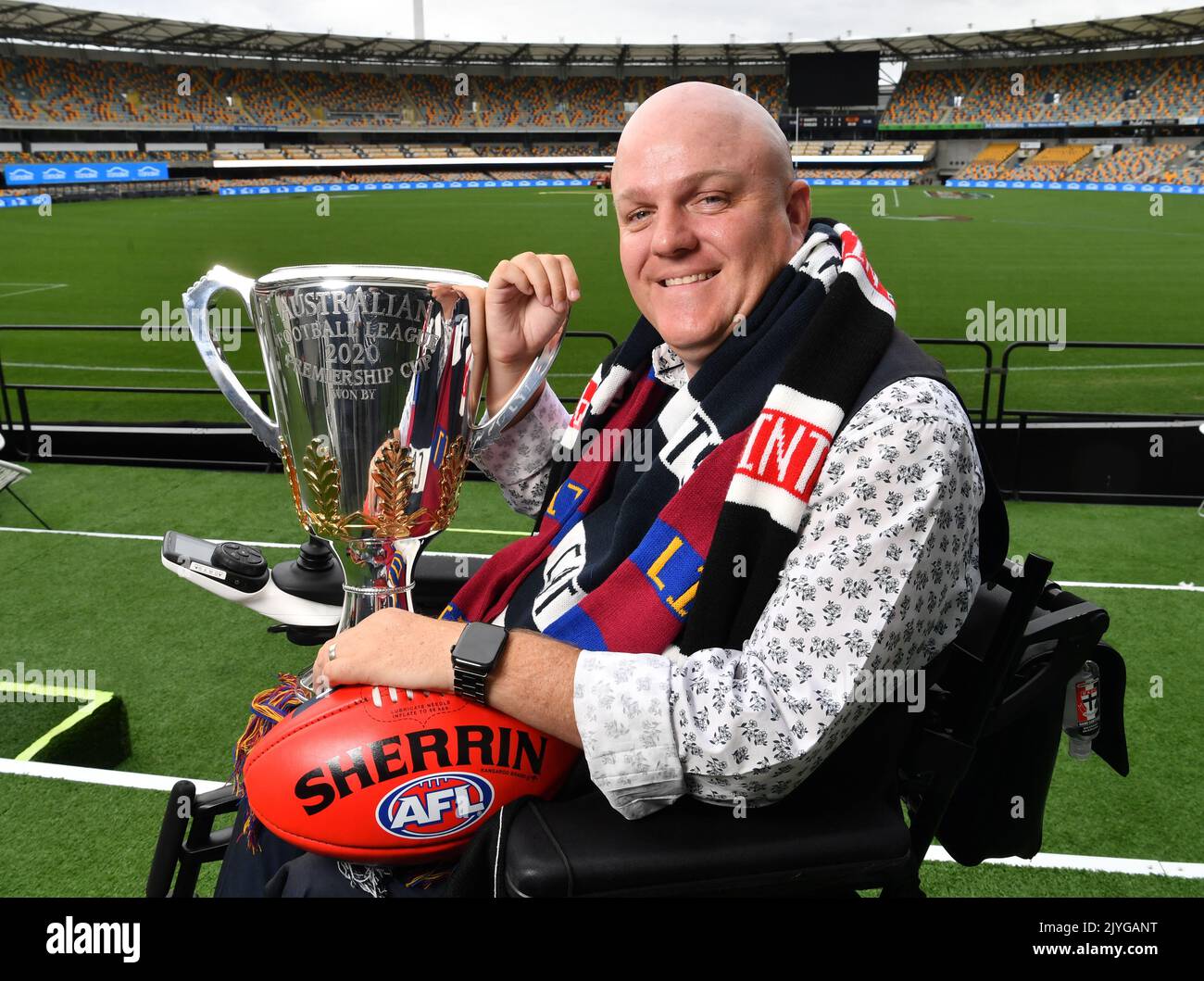 Tim McCallum is seen posing for a photograph with the AFL Premiership ...