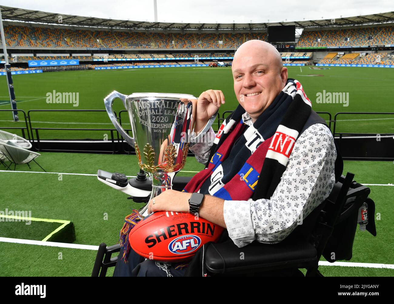 Tim McCallum is seen posing for a photograph with the AFL Premiership ...
