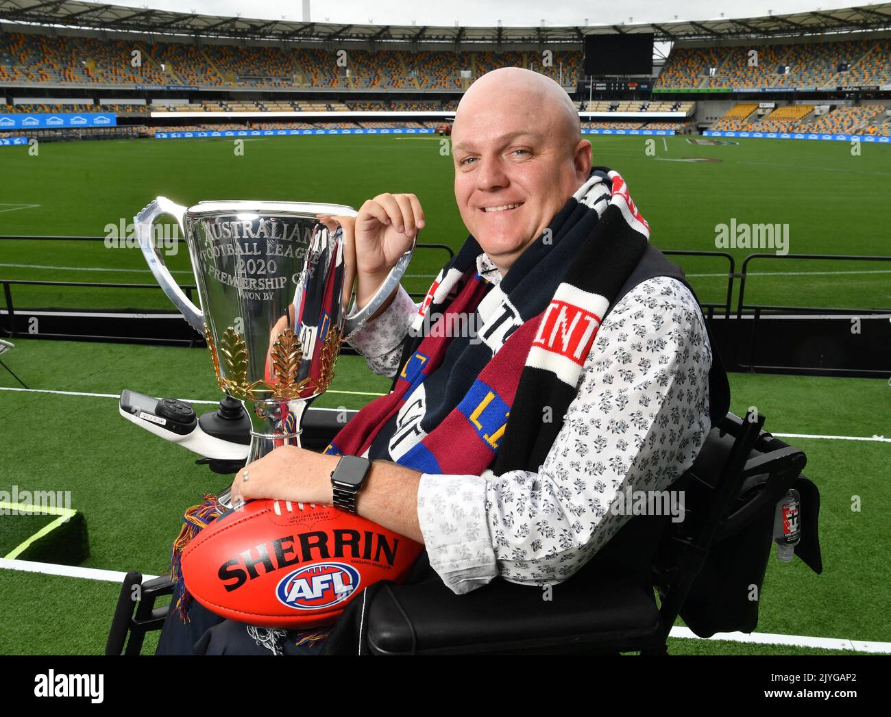 Tim McCallum is seen posing for a photograph with the AFL Premiership ...