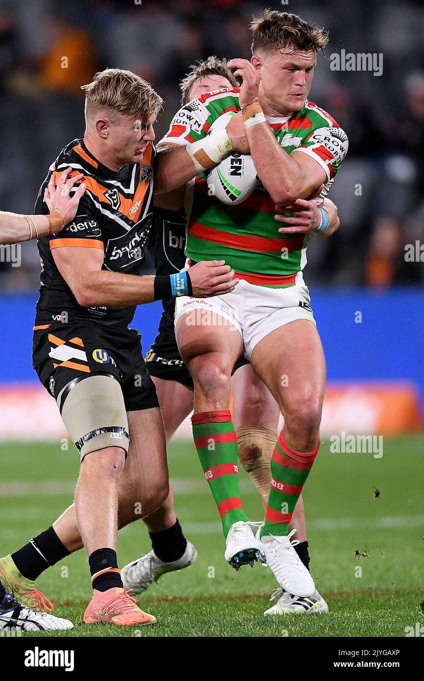 Liam Knight of the Rabbitohs is tackled by Luke Garner of the Tigers ...