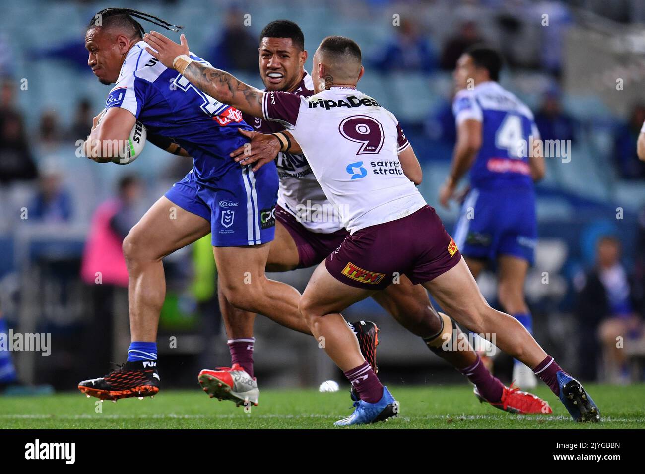 Sauaso Sue of the Bulldogs pushes through the Sea Eagles defence during ...