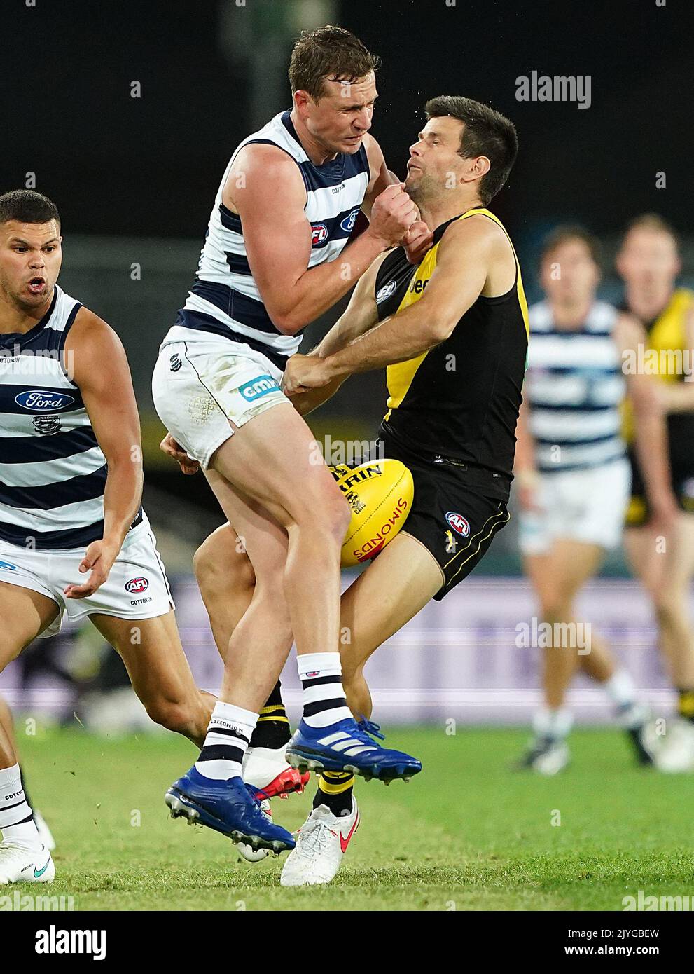 Mitch Duncan of the Cats puts a hit on Trent Cotchin of the Tigers ...