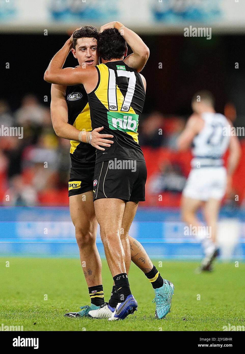 Jason Castagna of the Tigers (left) reacts with Daniel Rioli after ...