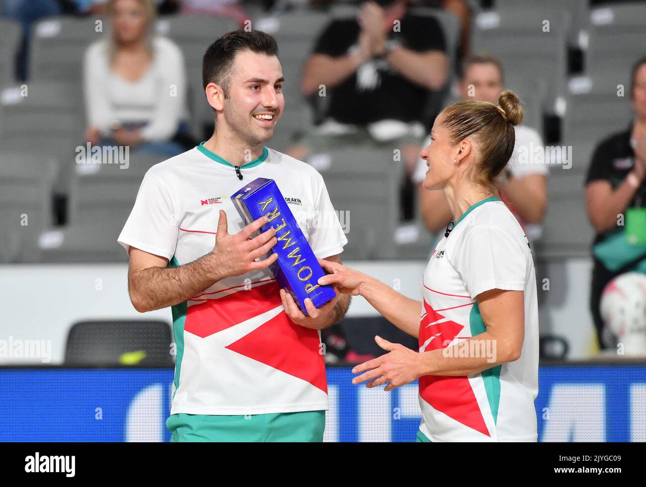 Umpires Justin Barnes (left) and Kate Wright (right) are seen during ...