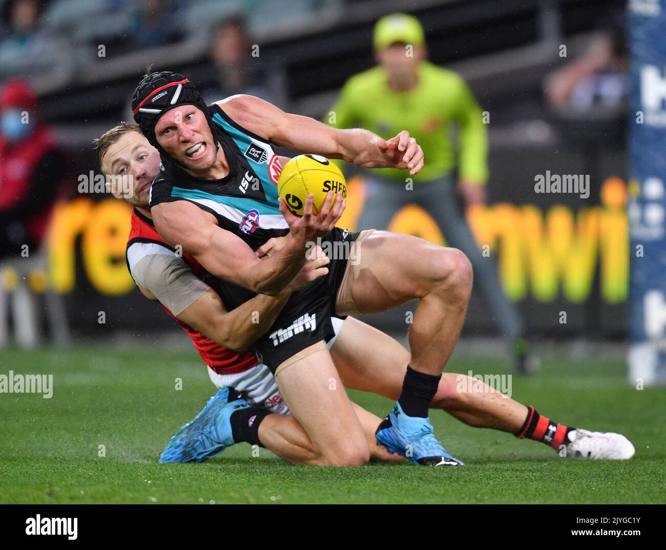 Brad Ebert of the Power is tackled by Devon Smith of the Bombers during ...