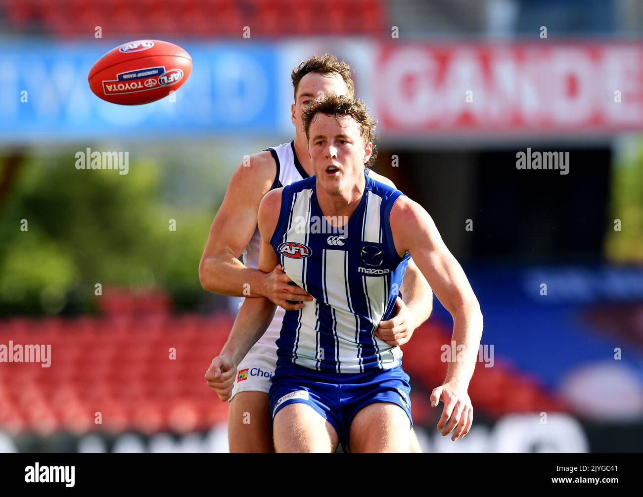 Nick Larkey of the Kangaroos (front) is held back by Taylan Duman of ...