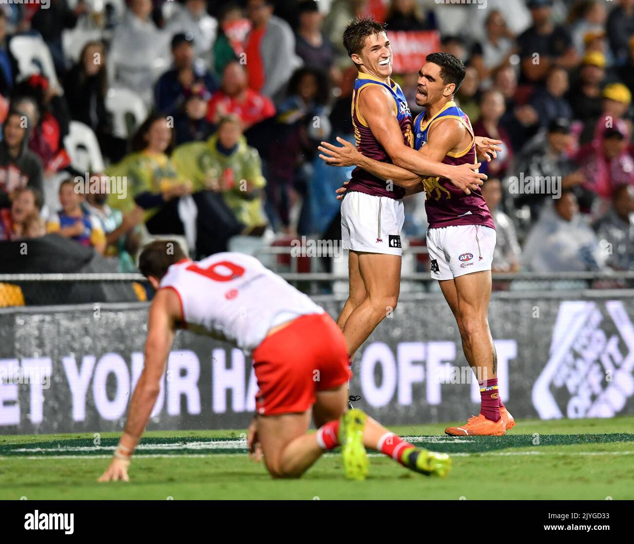 Zac Bailey (left) of the Lions celebrates kicking a goal with Charlie ...