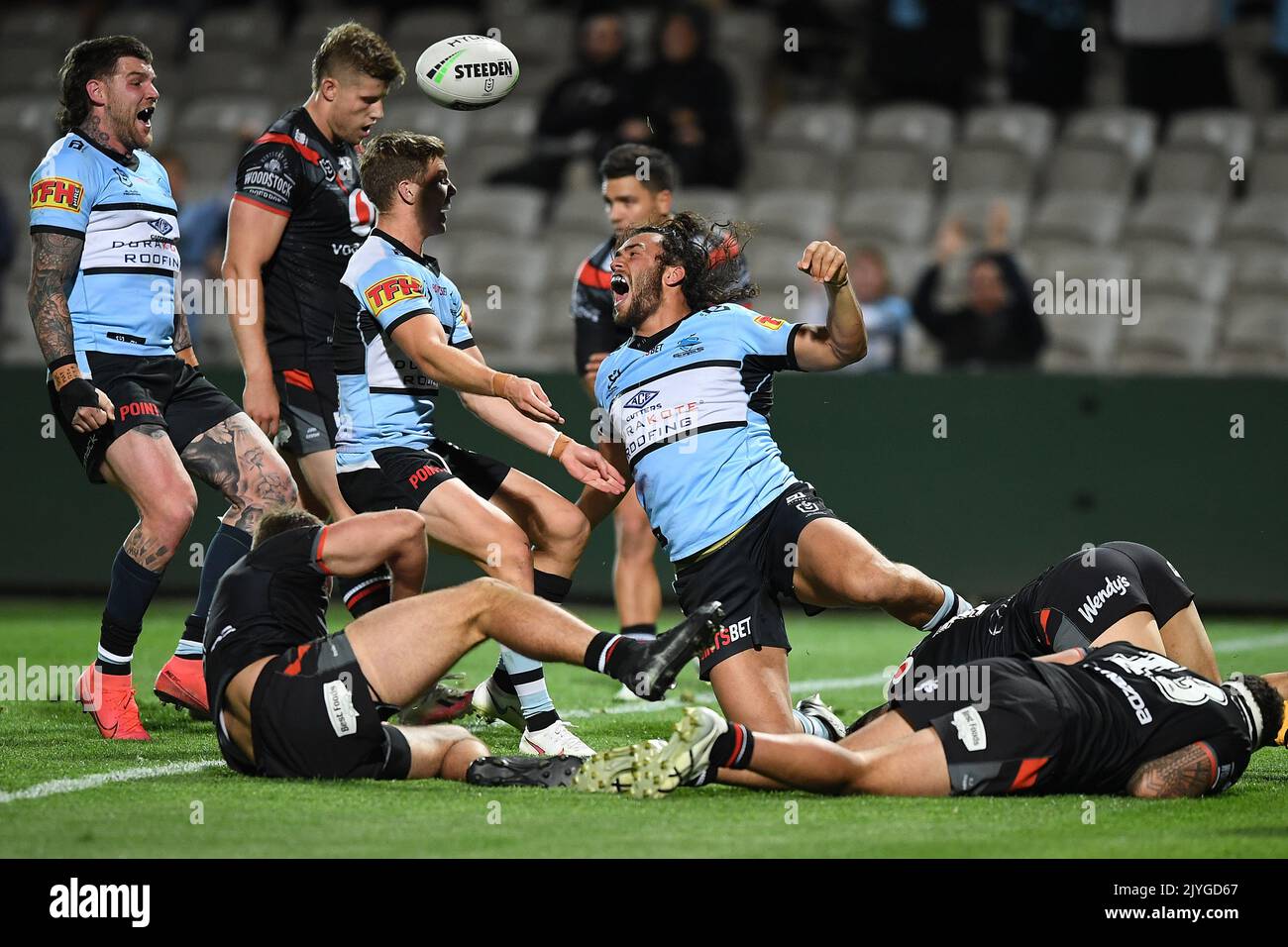 Toby Rudolf of the Sharks celebrates with teammates after scoring a try ...