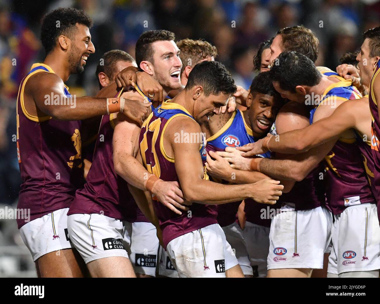 Keidean Coleman (centre) of the Lions celebrates kicking a goal with ...