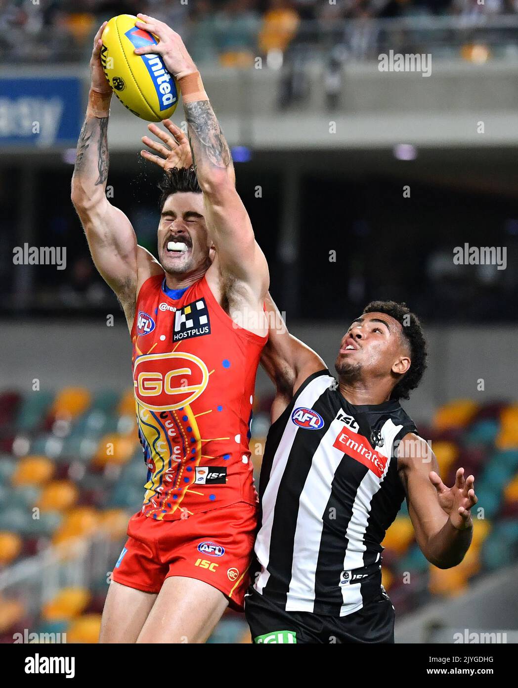 Alex Sexton (left) of the Suns takes a mark in front of Isaac Quaynor ...
