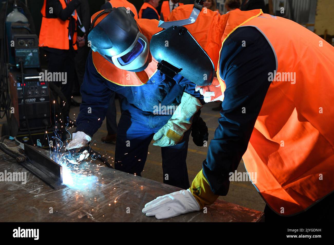 Prime Minister Scott Morrison (right) is shown how to weld steel during ...