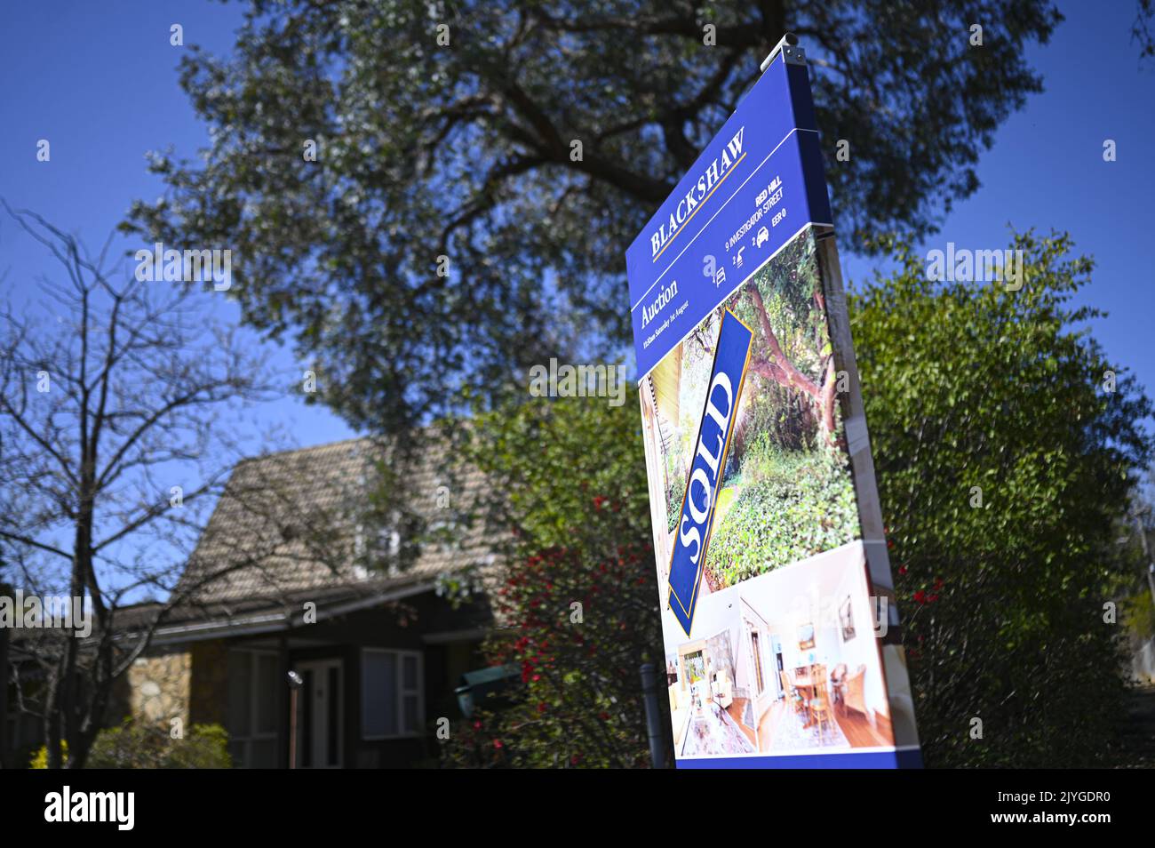 A ‘SOLD’ sticker is seen on a sale sign in front of a house in Canberra ...