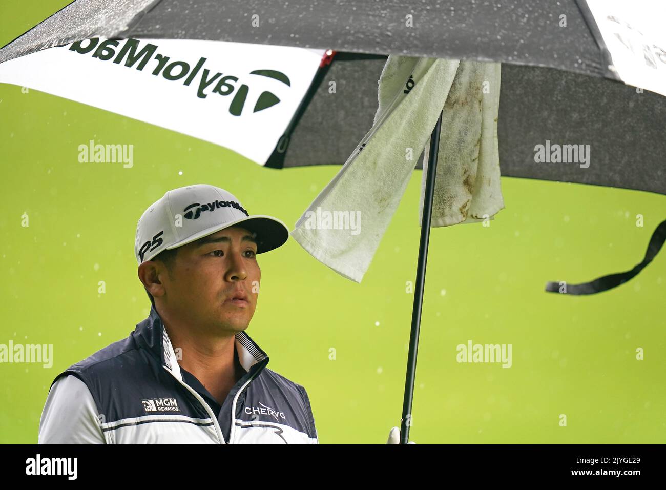 USA's Kurt Kitayama shields himself from the rain during day one of the ...
