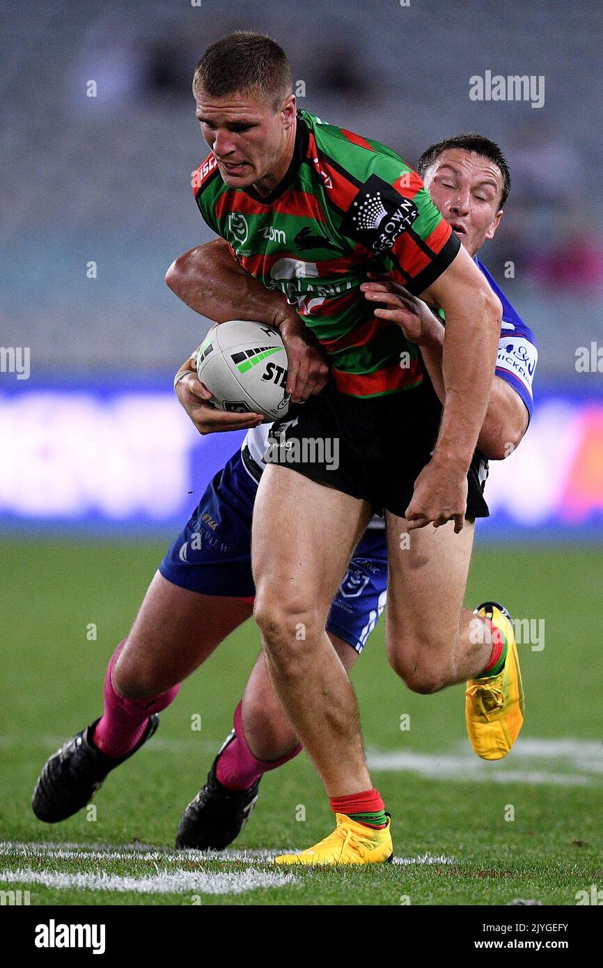 Jed Cartwright of the Rabbitohs is tackled by Josh Jackson of the ...