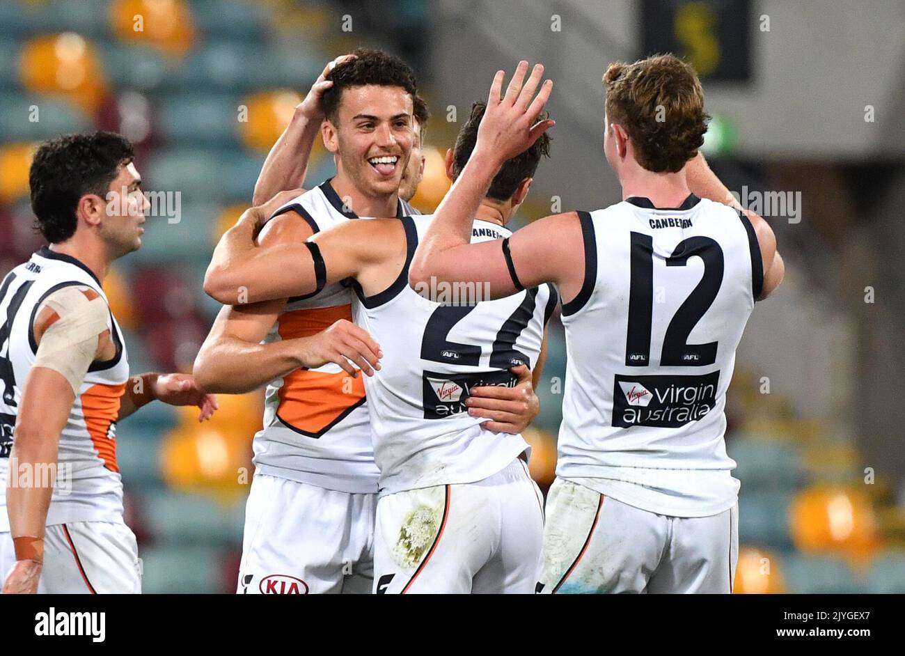 Jake Riccardi (centre) of the Giants celebrates kicking a goal with ...