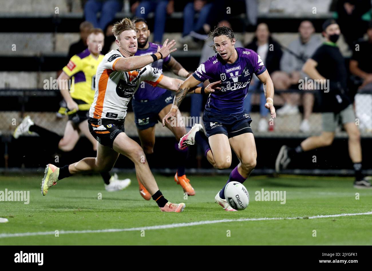 Luke Garner of Tigers pushes Nicho Hynes of Strom during Round 19 NRL ...