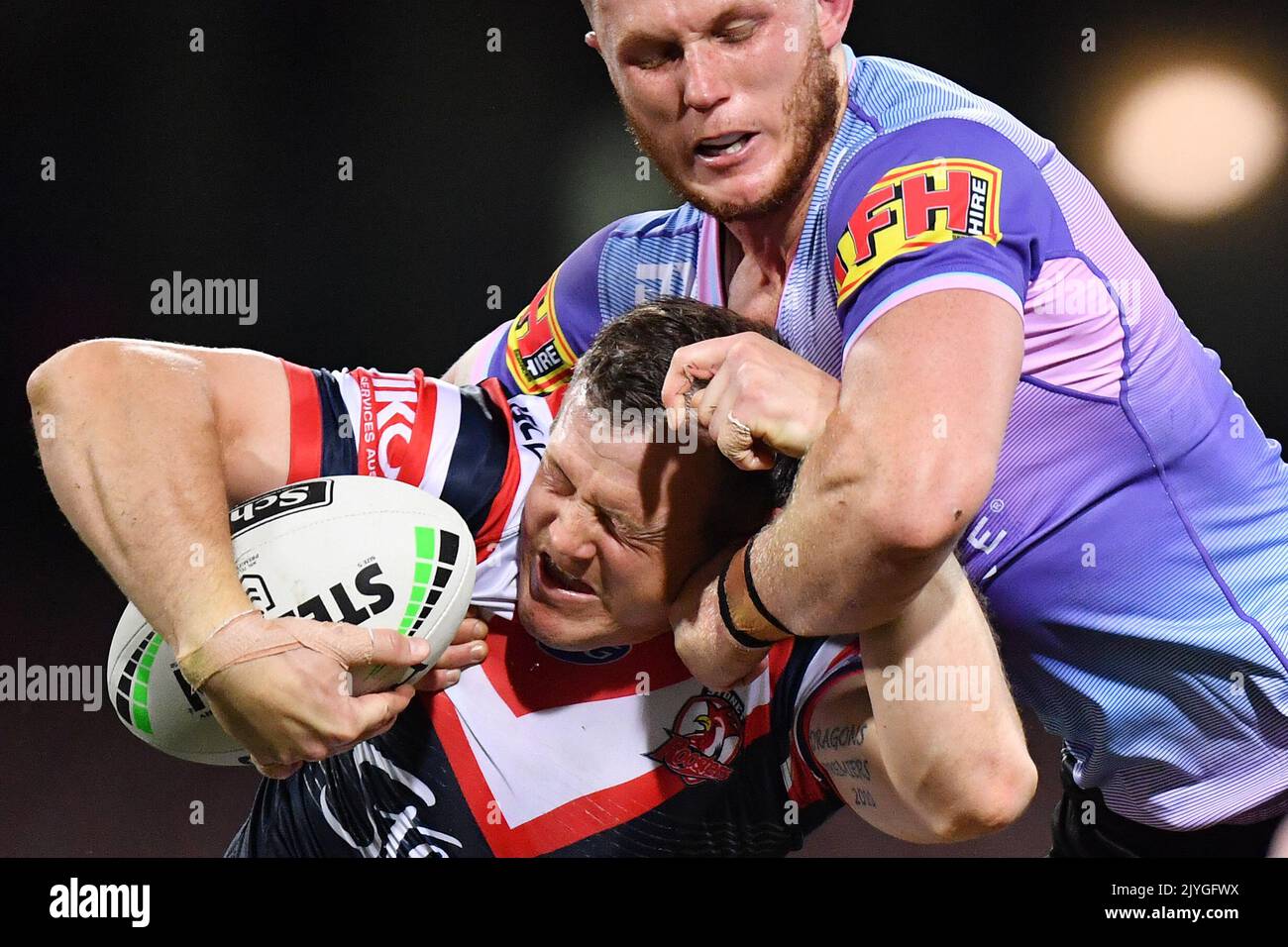 Brett Morris of the Roosters is tackled by Jack Williams of the Sharks ...