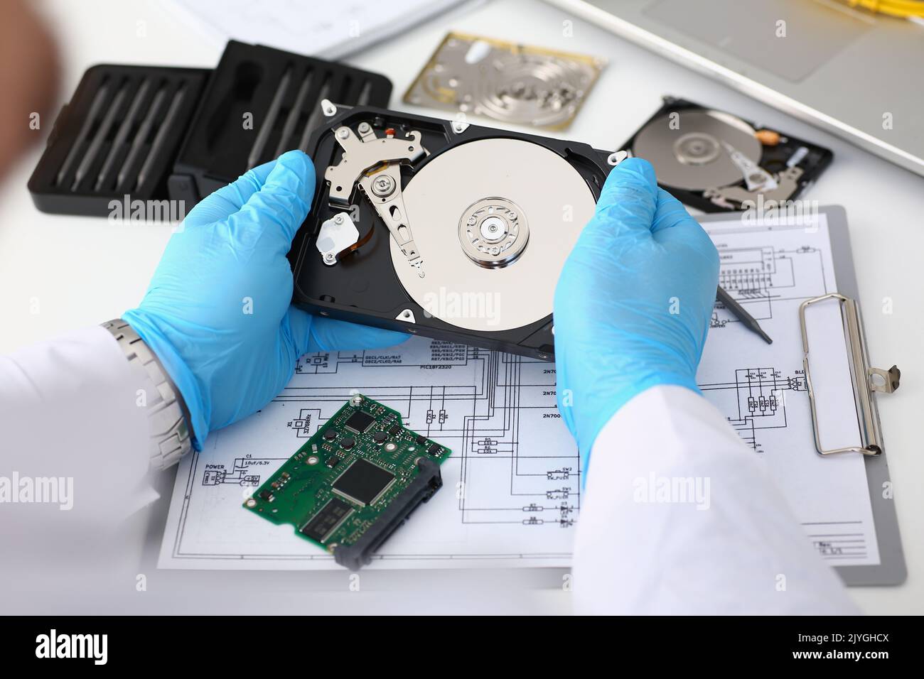 Technician repairs computer hard drive from motherboard Stock Photo - Alamy