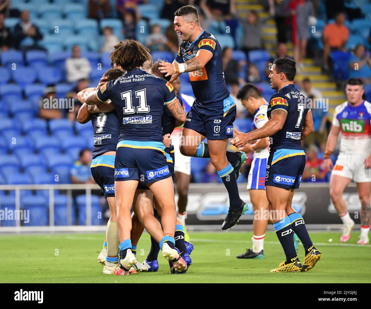 Mitch Rein (left) of the Titans celebrates scoring a try with team ...