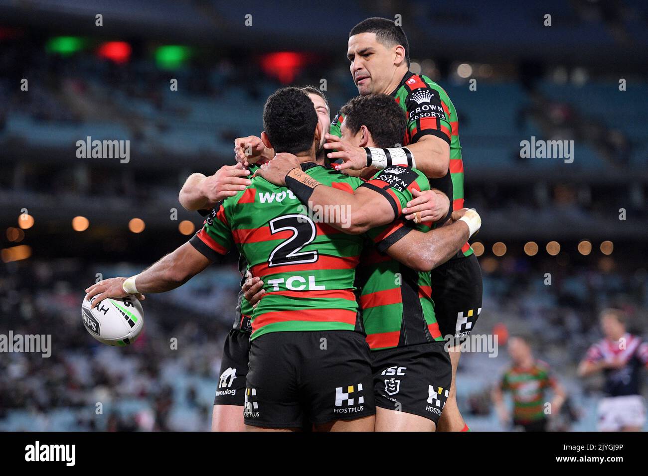 Alex Johnston of the Rabbitohs (left) celebrates with teammates after ...