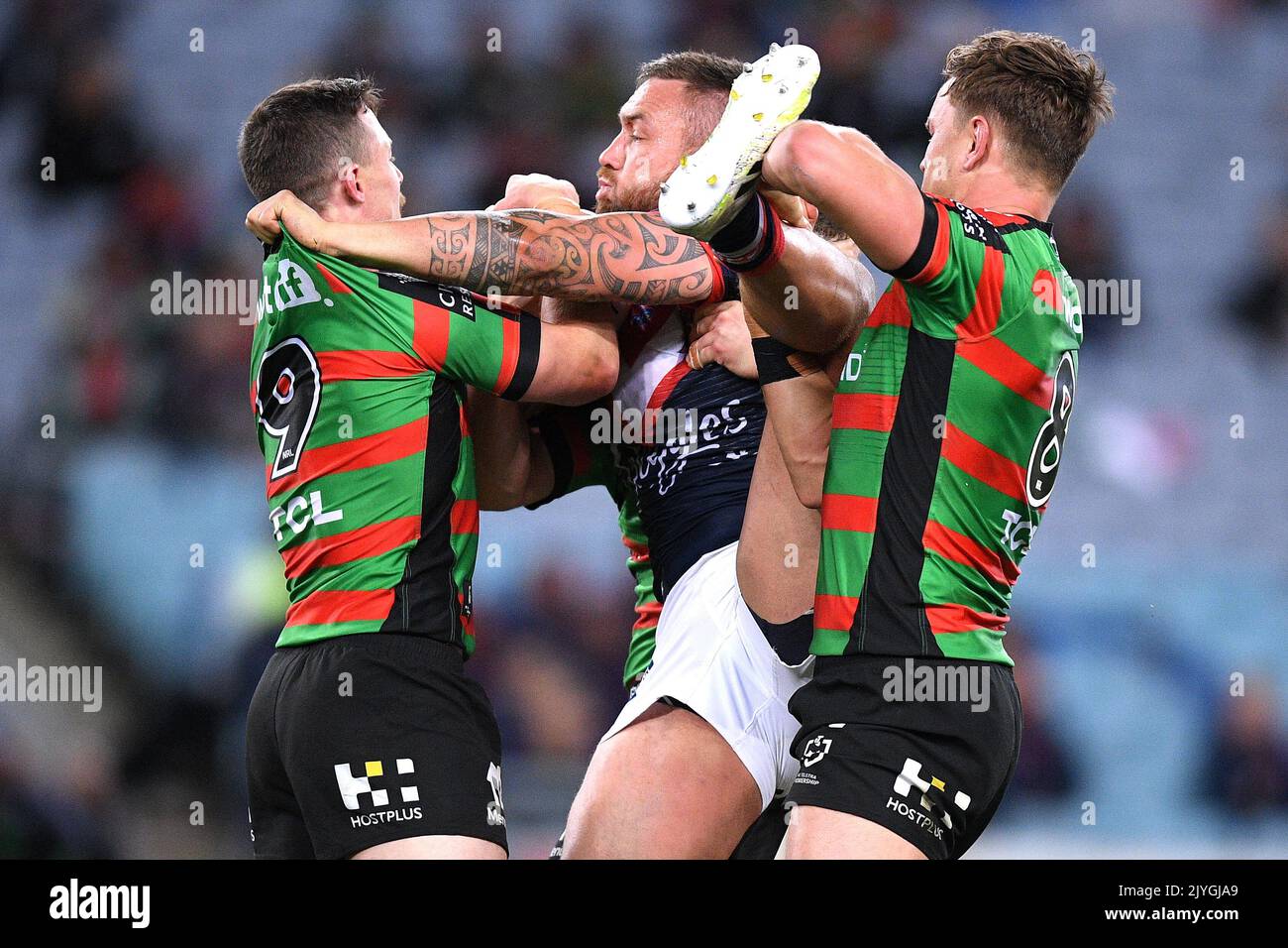 Jared Waerea-Hargreaves of the Roosters is tackled by Damien Cook (left ...