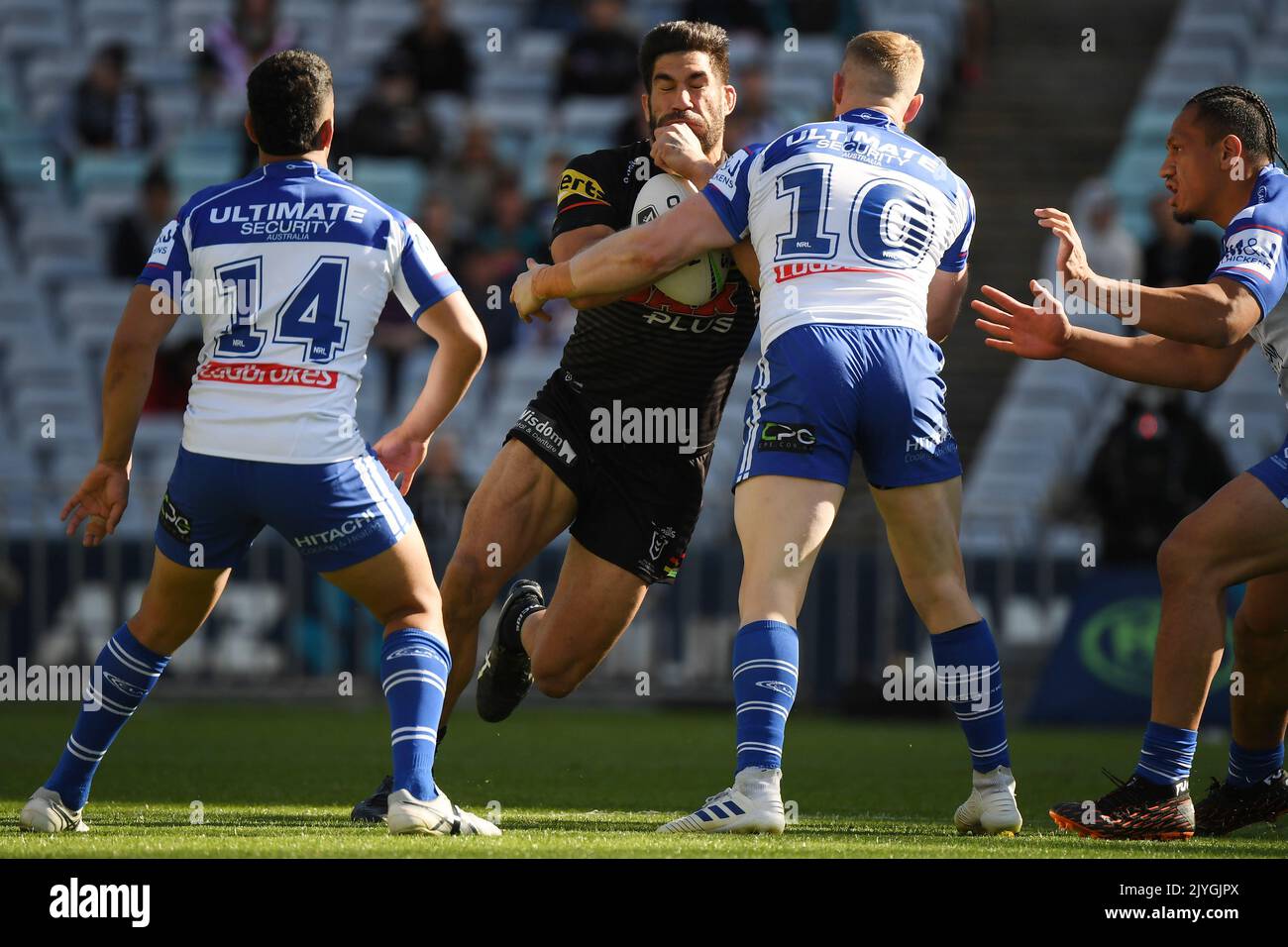 James Tamou of the Panthers is tackled by Luke Thompson of the Bulldogs ...