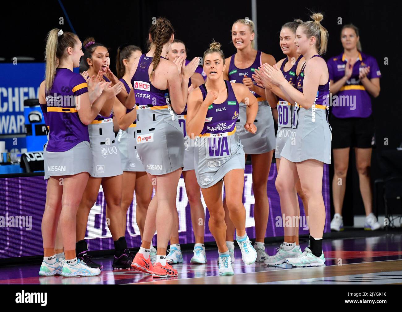 Lara Dunkley (centre) of the Firebirds is seen with team mates during ...