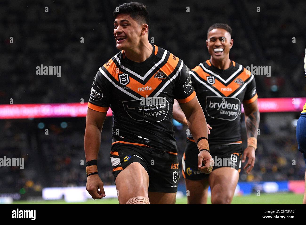 Tommy Talau of the Tigers celebrates after scoring a try during the ...