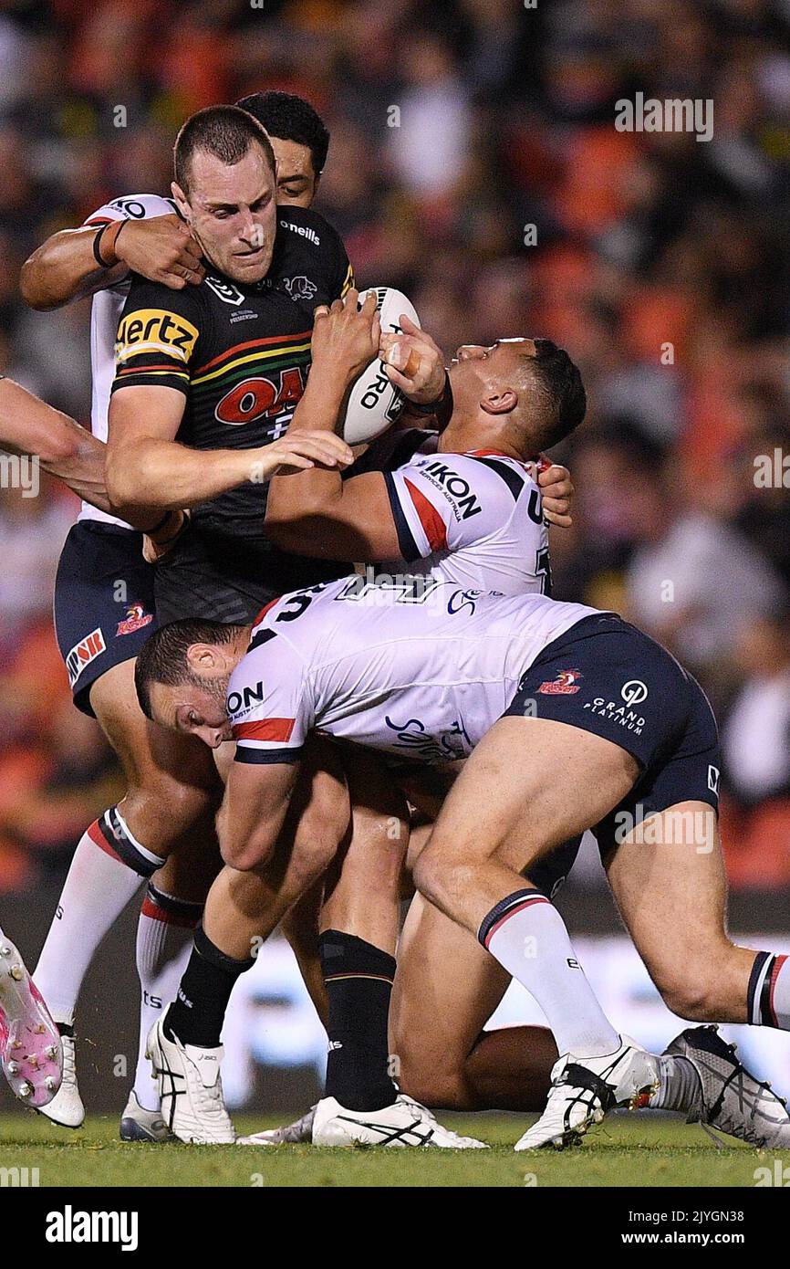 Issah Yeo of the Panthers is tackled by Isaac Liu (left) Siosiua ...