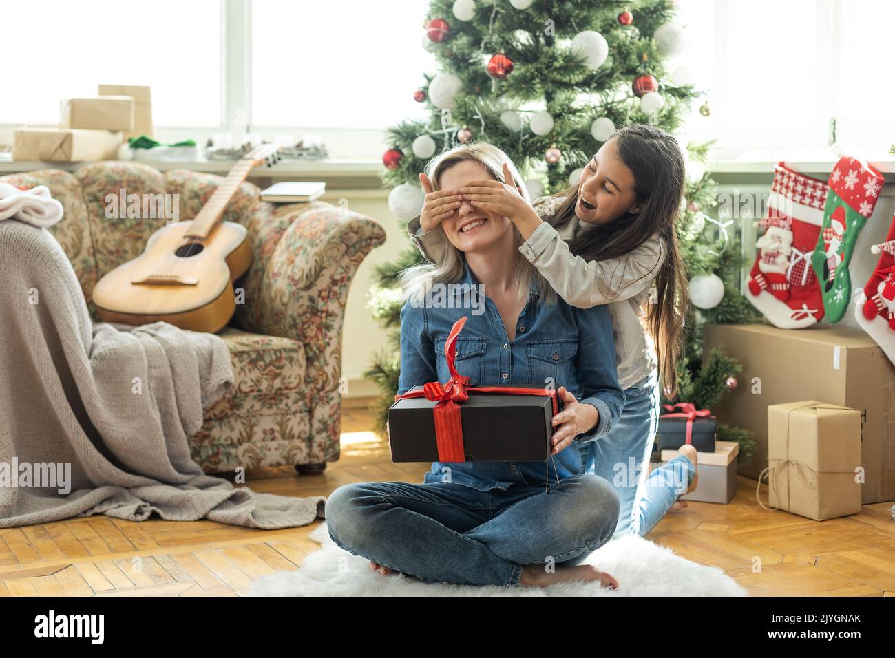 Mother sharing daughter presents hi-res stock photography and images ...