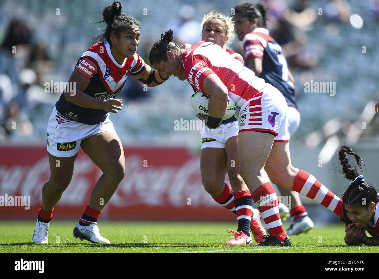 Stephanie Hancock of the Dragons (centre) is tackled during the Round 1 ...