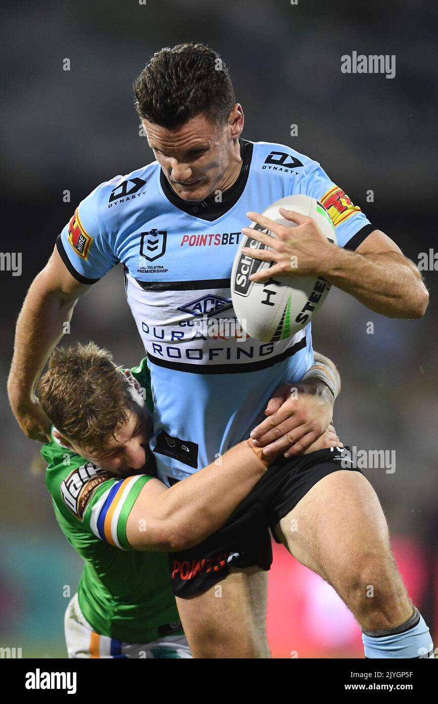 Connor Tracey of the Sharks tackled by George Williams of the Raiders ...