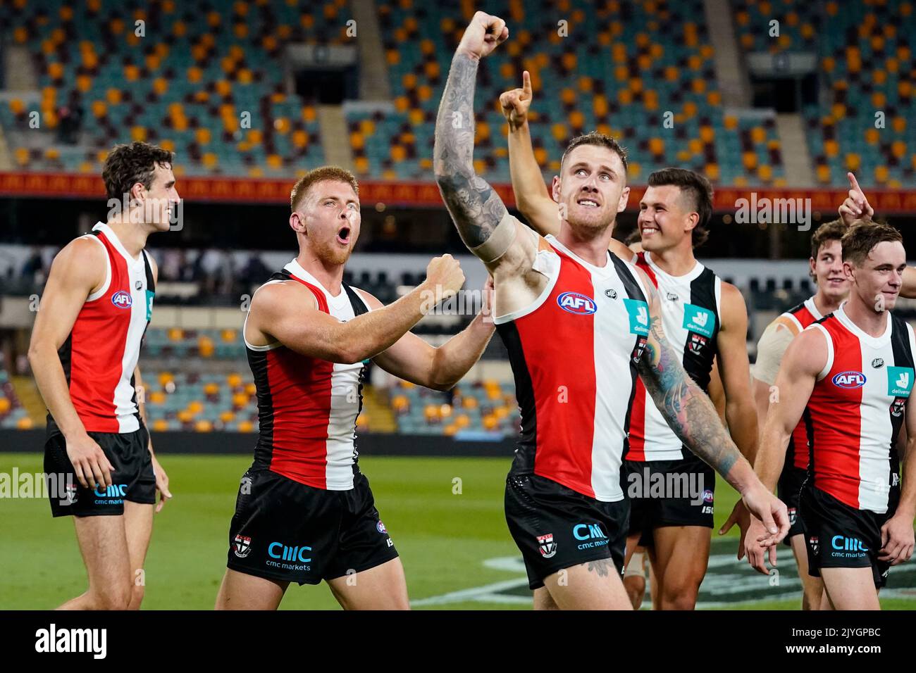 Tim Membrey of the Saints (centre) and teammates gesture to the crowd ...