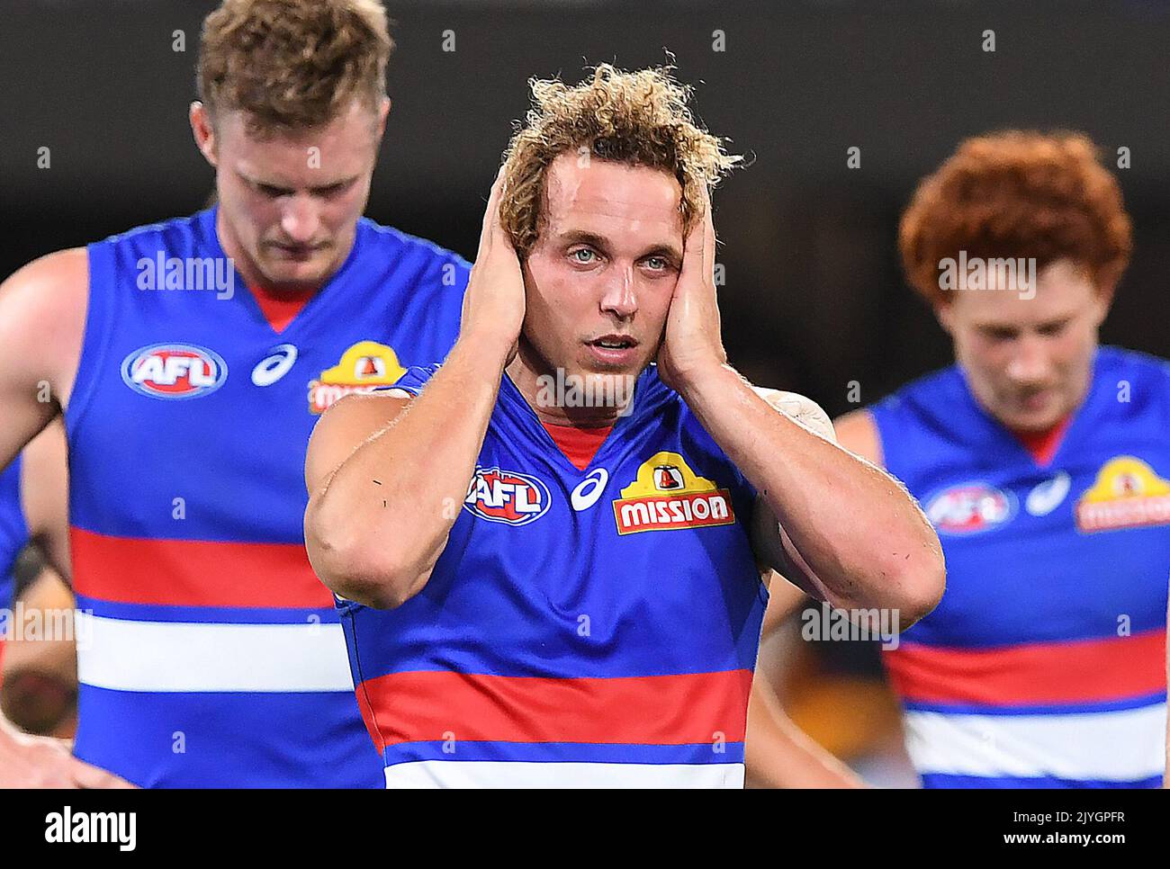 Mitch Wallis of the Bulldogs (centre) and teammates react following the ...